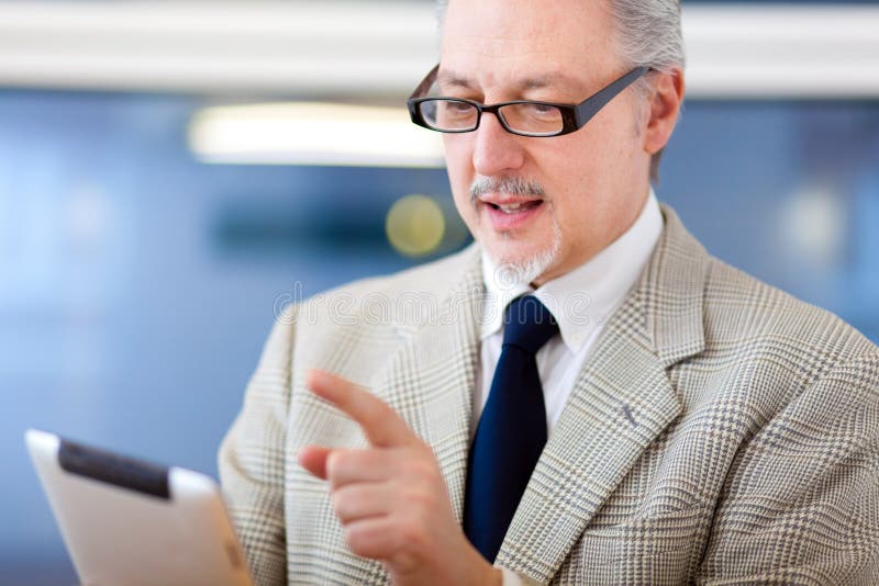 Businessman Using a Tablet in His Office Stock Photo - Image of ...