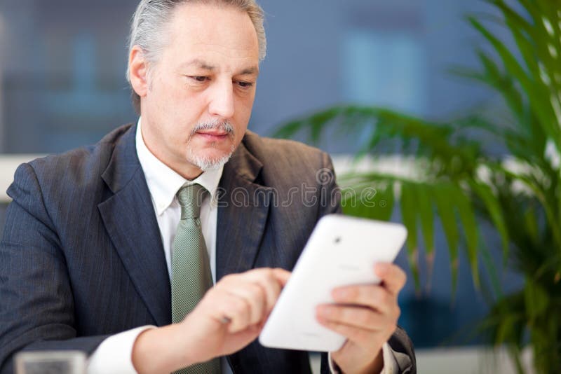 Businessman Using a Tablet in the Office Stock Photo - Image of ...