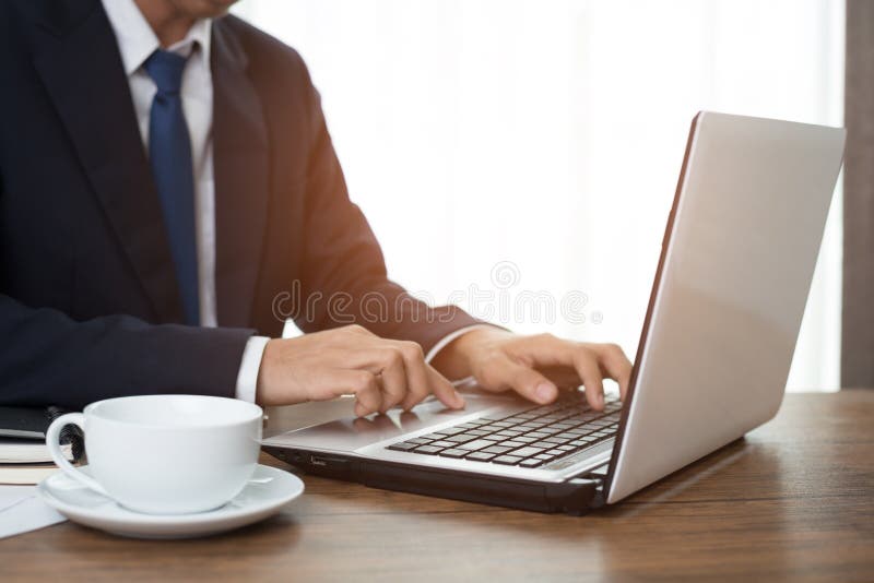 Businessman Using Working Laptop Computer on Wood Desk Stock Image ...