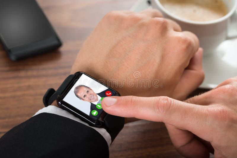 Businessman Video Conferencing with Colleague at Desk Stock Photo ...