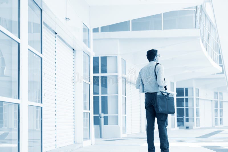 Businessman Walking through Office Building. Stock Photo - Image of ...