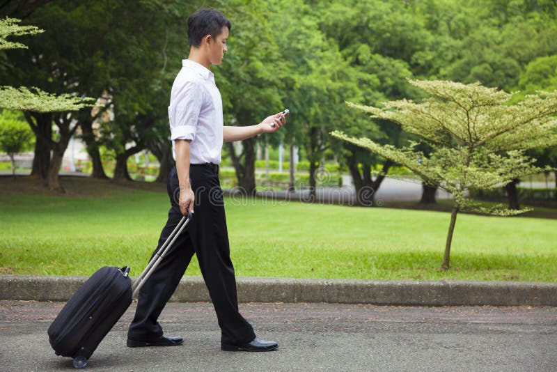Businessman Walking and Using a Phone on the Road Stock Photo - Image ...