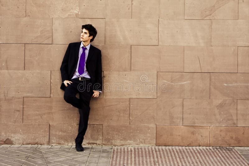 Businessman on wall stock photo. Image of handsome, alone - 4600094
