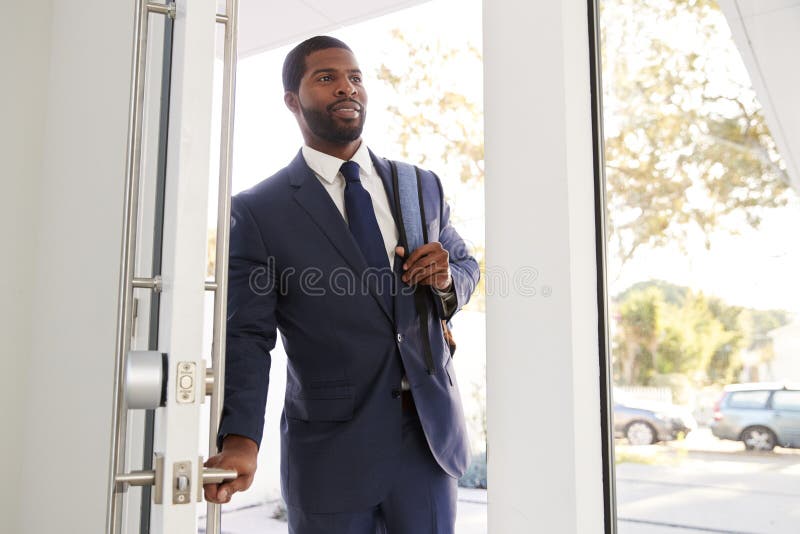 Man in Suit Opening Book at Library Desk Stock Image - Image of library ...