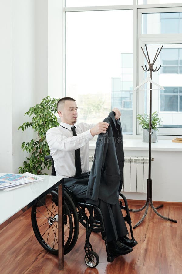 Businessman in Wheelchair Taking Off Jacket Stock Image - Image of ...
