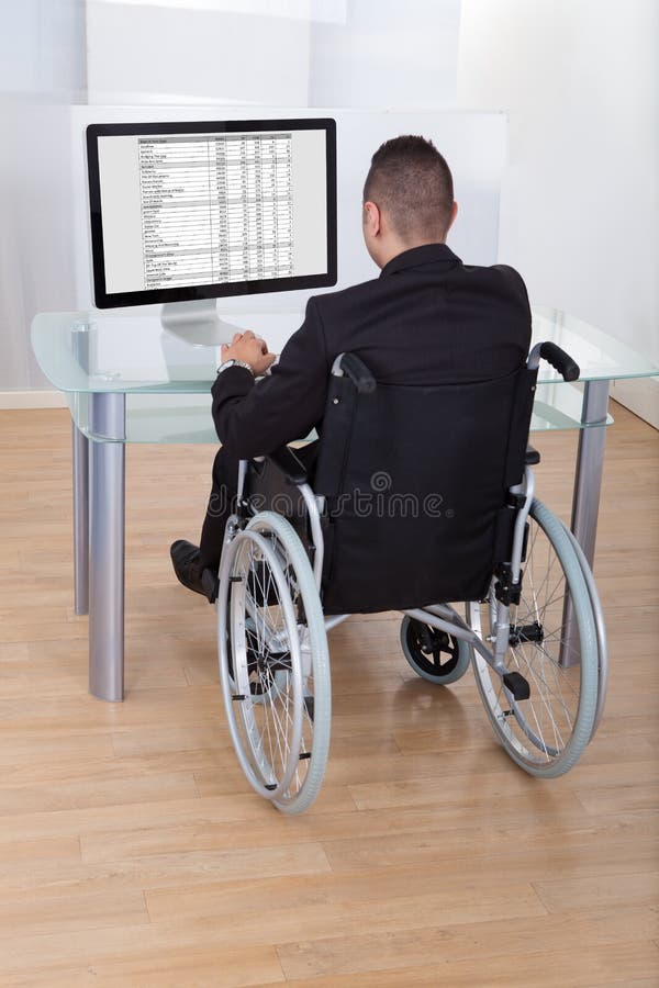 Businessman on Wheelchair Using Computer Stock Image - Image of office ...