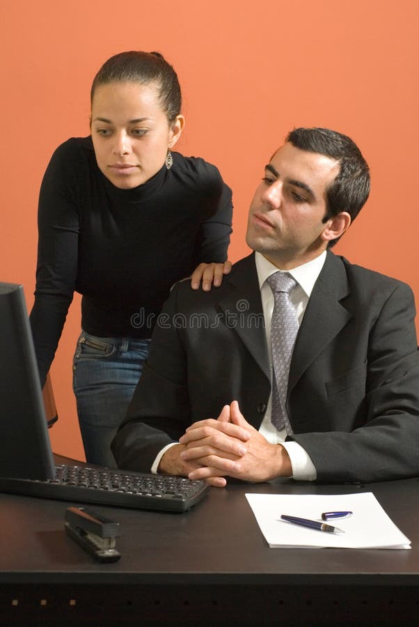 Businessman and Woman Look at Computer - Vertical Stock Photo - Image ...