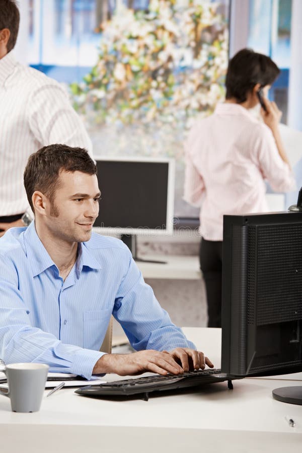 Businessman in Cubicle at Laptop Eating Sushi Stock Photo - Image of ...