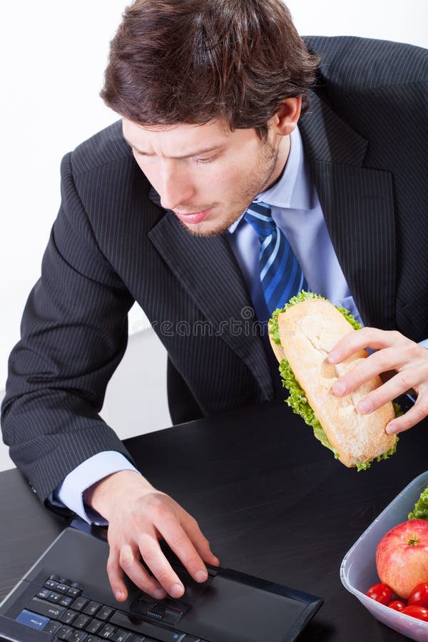 Businessman Working on the Computer and Eating Stock Photo - Image of ...