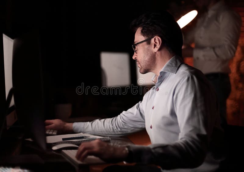 Businessman Working on a Computer at Night in a Dark Office Stock Image ...