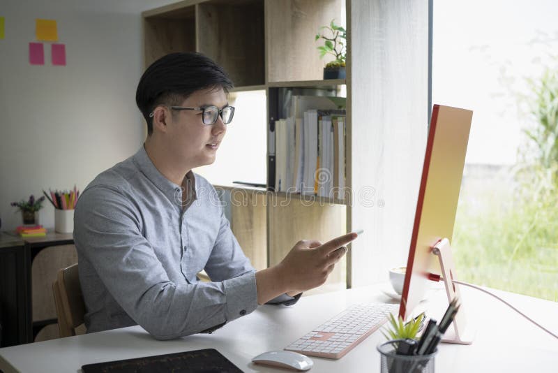 Businessman Working with Computer and Using Smart Phone. Stock Image ...