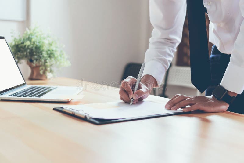 Businessman Working at His Office with Documents and Check the Accuracy ...