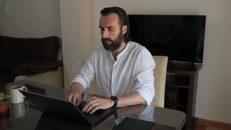 Businessman Working from Home Using Laptop at a Modern Office Desk ...