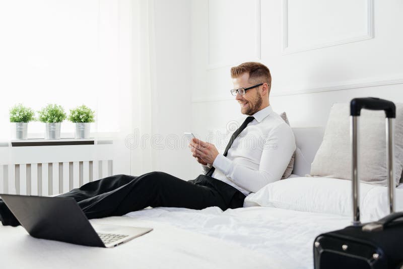 Businessman Working from a Hotel Room with His Mobile Phone Stock Image ...