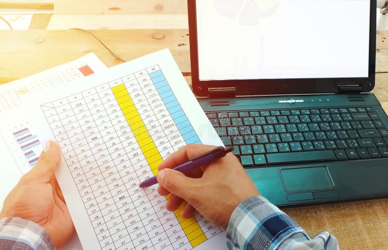 Businessman Working on a Laptop Computer and a Lot of Paperwork on the ...