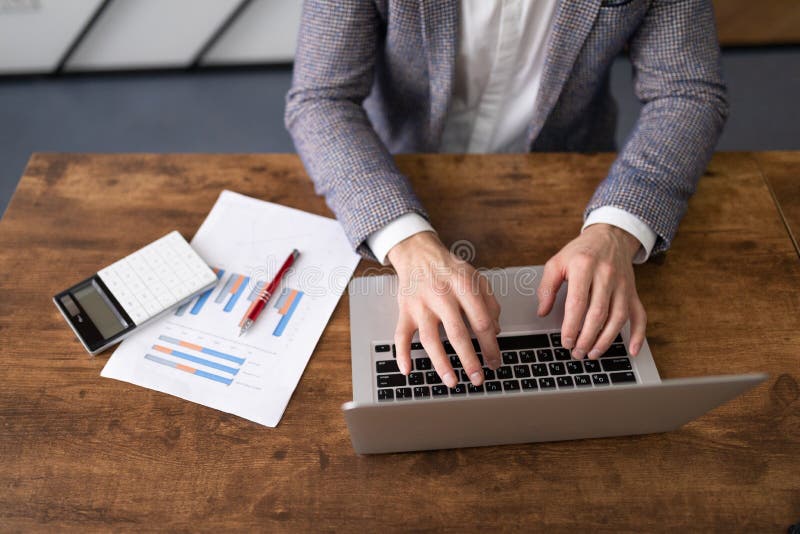 Businessman Working on Laptop with Documents Calculator on Table Top ...