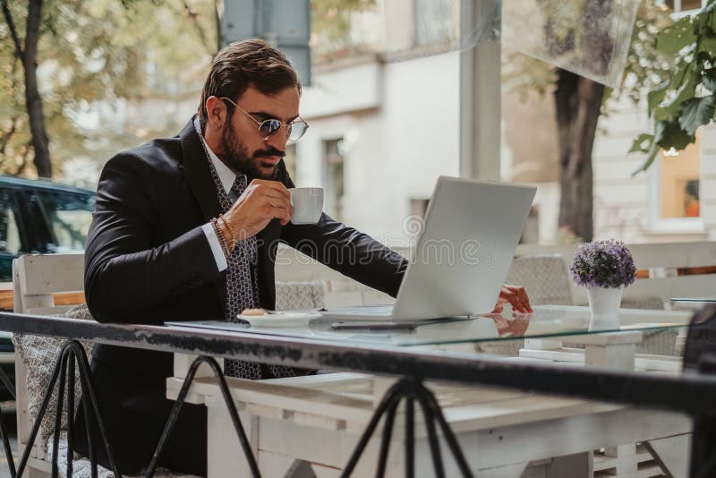 Businessman Working on a Laptop and Drinking Coffee Stock Photo - Image ...