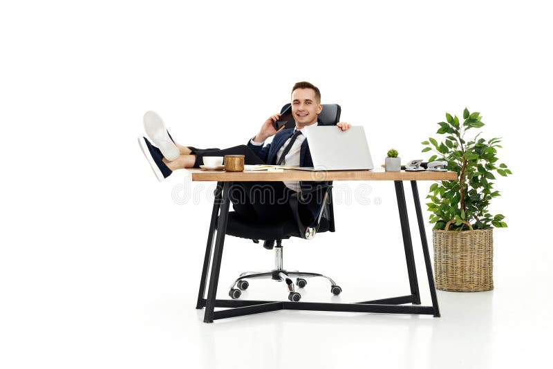 Businessman Working with Laptop and Having Phone Conversation with ...