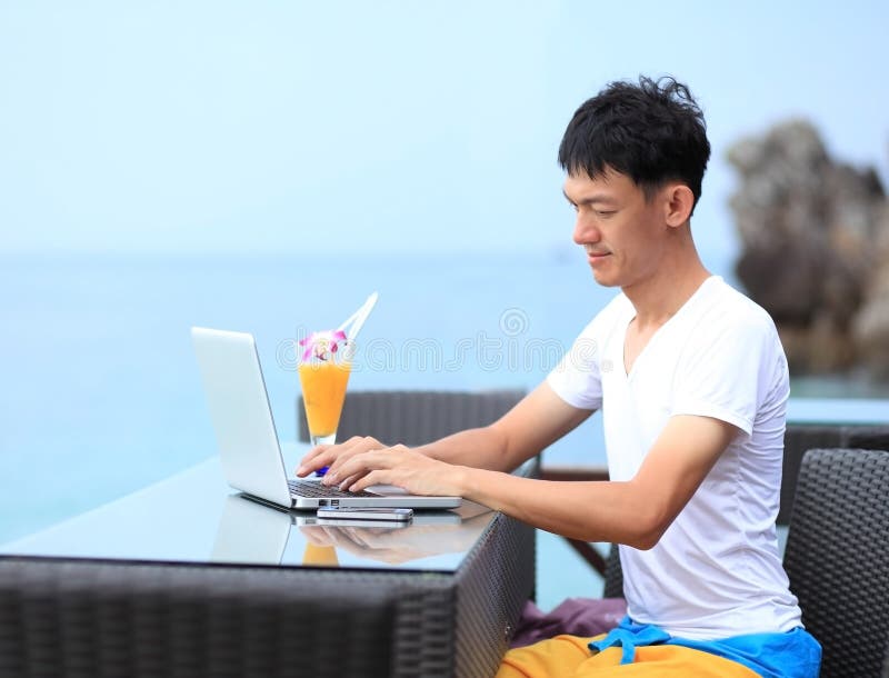 Businessman Working with Laptop Sitting at the Beach Outdoor. Stock ...