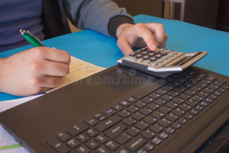 Businessman Working on Office Desk with Calculator, a Computer, a Pen ...