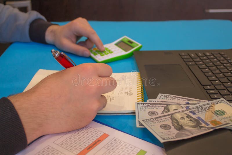 Businessman Working on Office Desk with Calculator, a Computer, a Pen ...