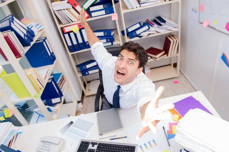 Businessman Working in the Office with Piles of Books and Papers Stock ...