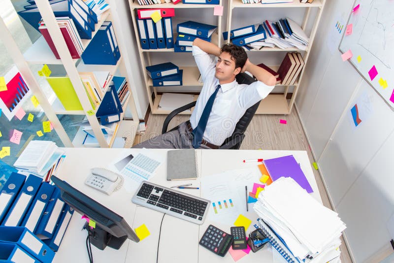 Businessman Working in the Office with Piles of Books and Papers Stock ...