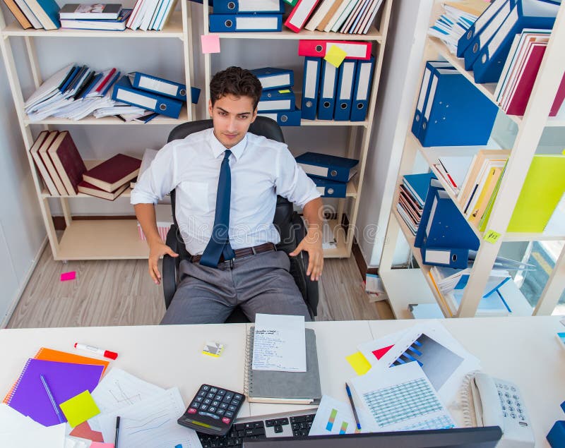 Businessman Working in the Office with Piles of Books and Papers Stock ...