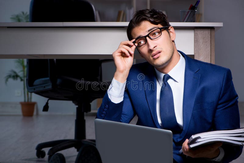 The Businessman Working Overtime Long Hours Late in Office Stock Photo ... The Businessman Working Overtime Long Hours Late in Office Stock Photo ...