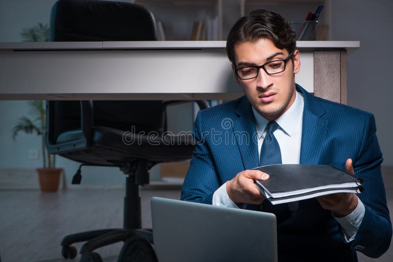 The Businessman Working Overtime Long Hours Late in Office Stock Photo ... The Businessman Working Overtime Long Hours Late in Office Stock Photo ...