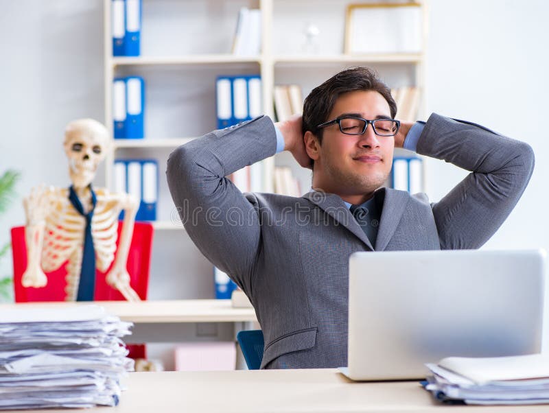 Businessman Working with Skeleton in Office Stock Photo - Image of ...