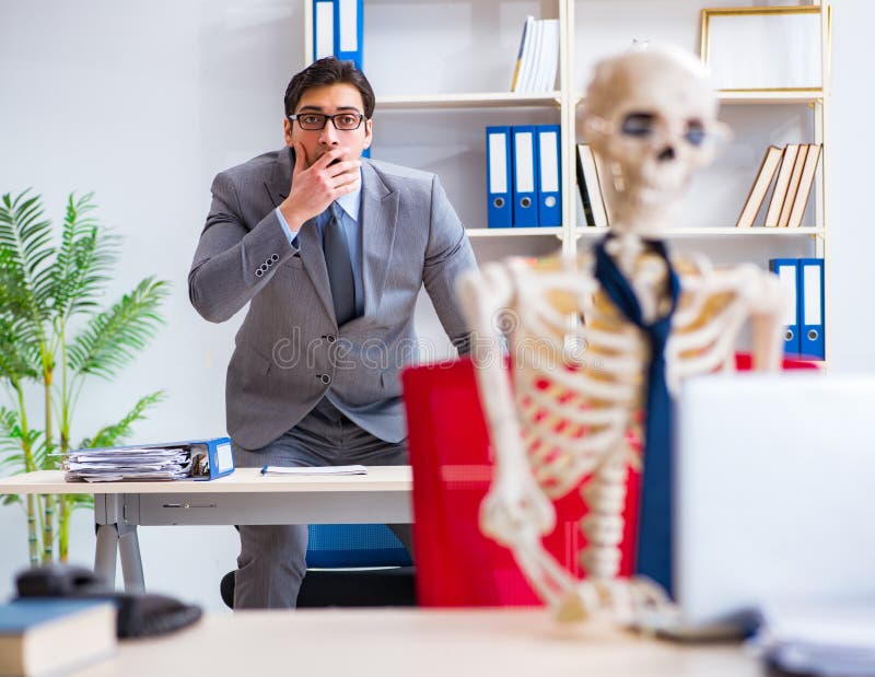Businessman Working with Skeleton in Office Stock Photo - Image of ...