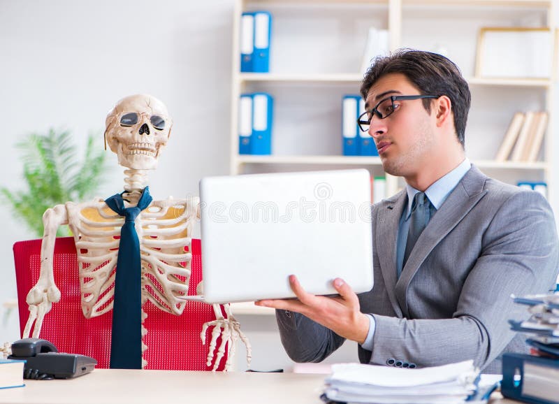 Businessman Working with Skeleton in Office Stock Photo - Image of ...
