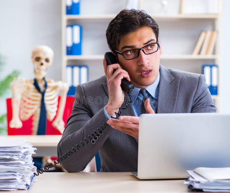 Businessman Working with Skeleton in Office Stock Photo - Image of ...