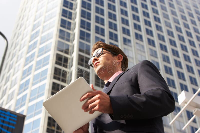 Businessman Working on Tablet Computer Outside Office Stock Photo ...