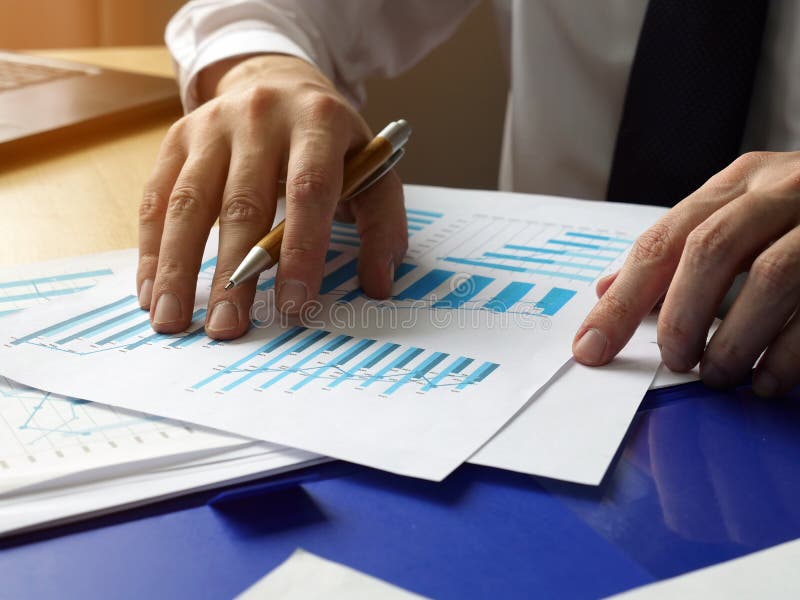 Businessman Works with Business Charts and a Stack of Papers. Stock ...