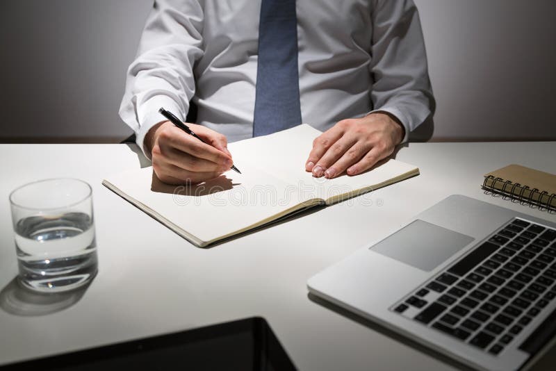Businessman Writing in Journal Stock Photo - Image of glass, notepad ...