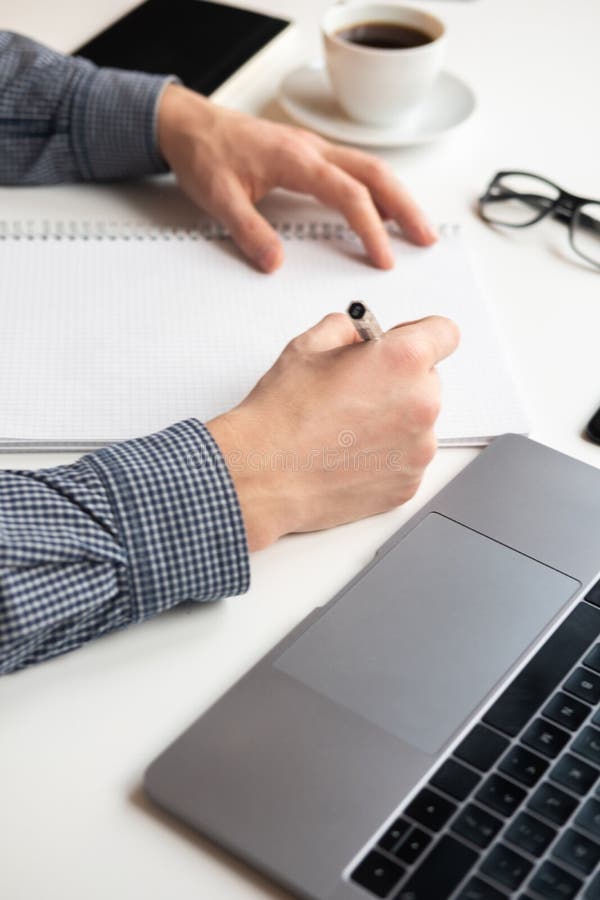 Businessman Writing in Notebook. White Table with Coffee Laptop ...
