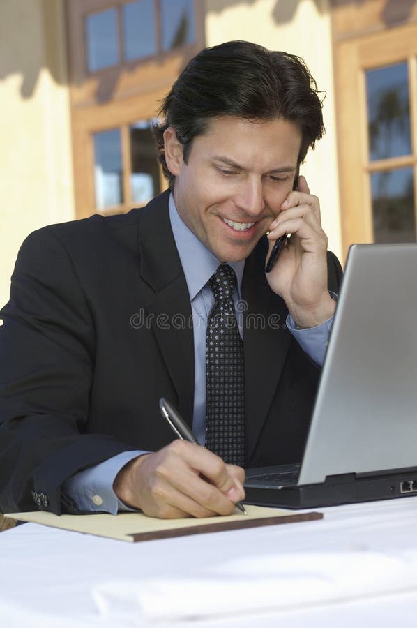 Man on Call while Writing on Notepad in Laundry Stock Photo - Image of ...