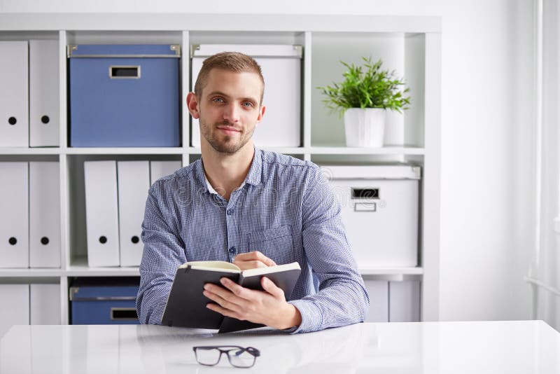 Man in the Office Writing Plan in Diary Stock Image - Image of smile ...