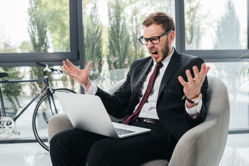 Businessman Yelling while Working on Laptop at Modern Office Stock ...