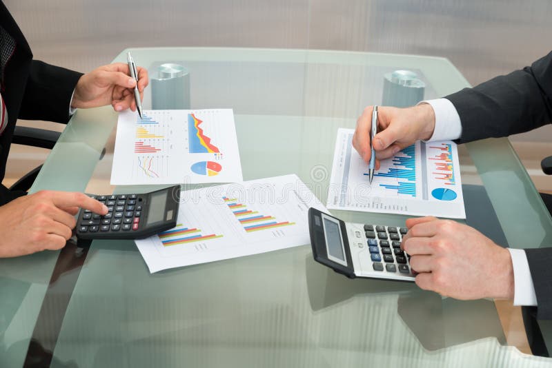 Businessmen Analyzing the Graph on Office Desk Stock Photo - Image of ...