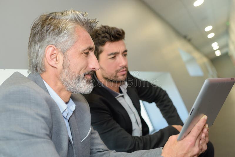 Businessmen in Deep Discussion while Standing in Corridor Stock Image ...