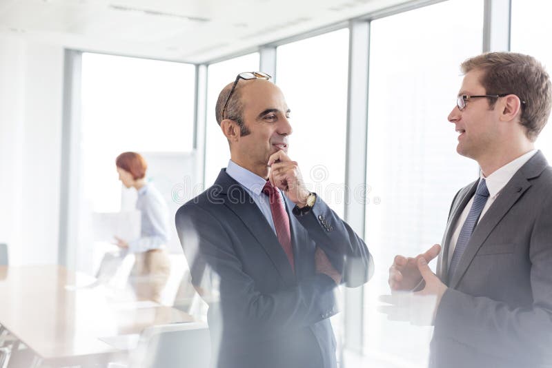 Businessmen Discussing while Standing in Boardroom during Meeting at ...