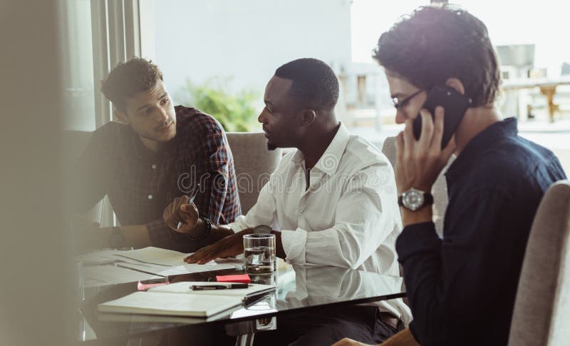 Businessmen in a meeting stock image. Image of indoors - 116946387