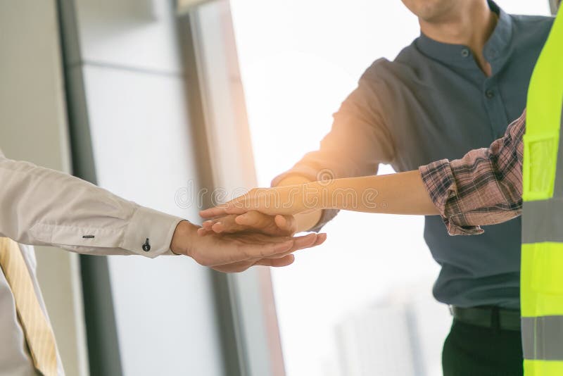 Businessmen and Engineers Stack Hands of Teamwork Join Together To ...