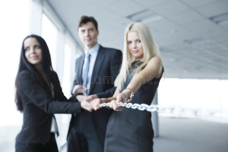 Businessmen pulling chain stock image. Image of young - 125754743