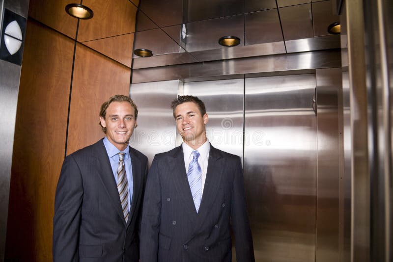Businessmen Standing in Elevator Stock Image - Image of executive, suit ...