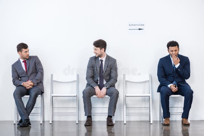 Businessmen Sitting in Queue and Waiting for Interview in Office Stock ...