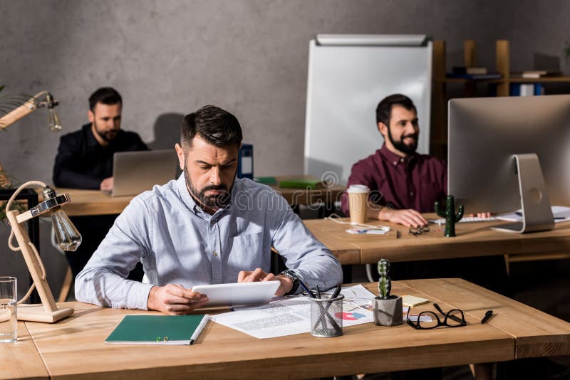 Businessmen Sitting at Working Tables with Different Stock Image ...